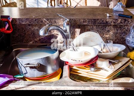 Washing dishes, Close up of utensils soaking in kitchen sink Stock ...