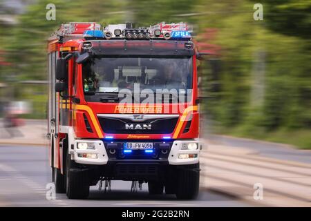 Dresdne, Germany. 20th May, 2021. Fire engine with blue light on duty ...