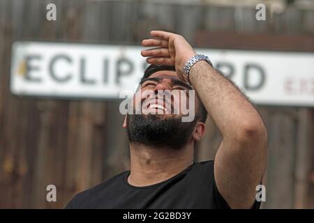 Hamza Qureshi looks towards the skies from Eclipse Road, in east London ...