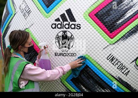 Aimee Harper cleans a giant ball as finishing preparations are made to ...