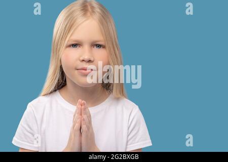 little girl doing namaste on white background Stock Photo - Alamy