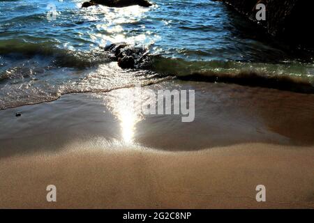 Heat at sea, waves glisten in the sun, beach vacation Stock Photo - Alamy