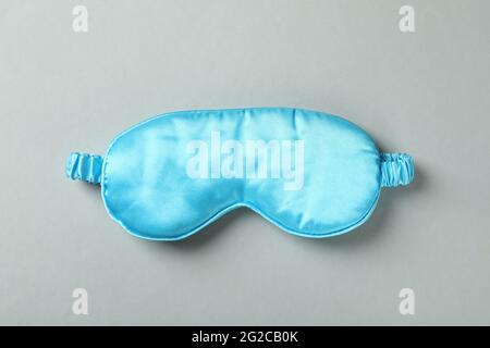 Blue sleep mask on gray background, space for text Stock Photo - Alamy
