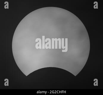 A partial lunar eclipse is visible through projectors spotlights in ...