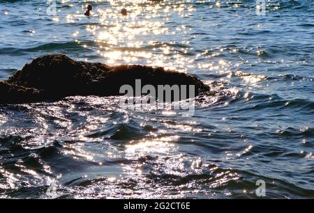 Heat at sea, waves glisten in the sun, beach vacation Stock Photo - Alamy