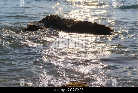 Heat at sea, waves glisten in the sun, beach vacation Stock Photo - Alamy