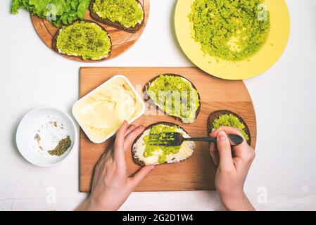 Appetizing appetizer with avocado. The process of making sandwiches for ...