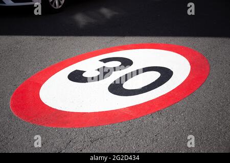 30 kilometers hour speed limit sign painted on city road Stock Photo - Alamy