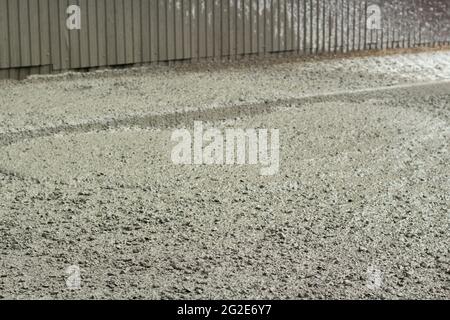 Liquid cement at a construction site. Cement spilled onto the road. The ...