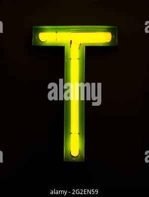 Neon shining sign in yellow warm color on a brick wall with the ...