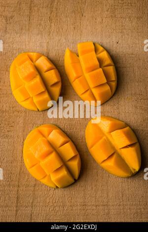 Alphonso mango slices on wooden background stock image with selective ...
