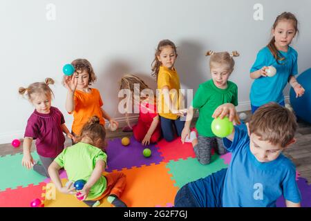 Little boy throwing a yellow ball Stock Photo - Alamy
