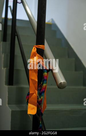 A vertical shot of a pole with colored ribbons and flowers on a ...