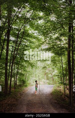 Teen boy walking and looking up with headphones isolated on white ...