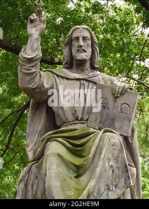 Damaged Statue of Jesus on the Cross without legs at a church wall in ...