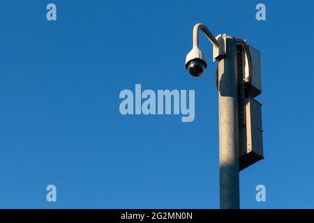 360 Degree CCTV security camera fixed on a pole on a blue sky ...