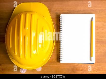 Checked notebook pen hard hat measuring tape Stock Photo - Alamy