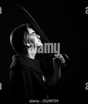 Soldier of past times standing sideways with his rifle slung over his ...