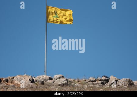 Yellow Flag of Hezbollah with a blue sky background on the Israeli ...