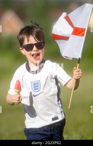 Cambridge. UK. 13th June 2021. Albert Mitchell, 4 in his England kit is ...