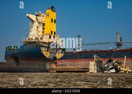Alang ,01, February, 2016:Small red boat and large ship brought to Alang Ship Breaking Yard for ...