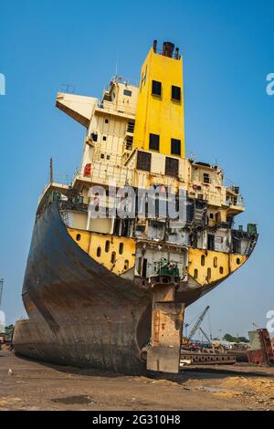 Alang ,01, February, 2016:Small red boat and large ship brought to Alang Ship Breaking Yard for ...