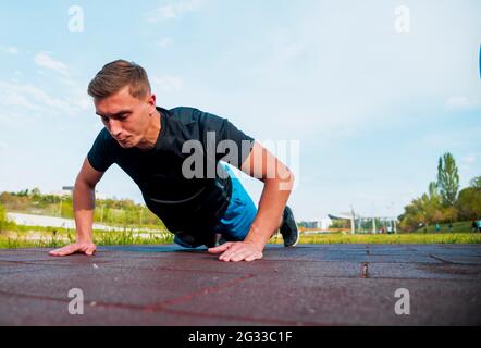 Sportsman doing clapping push-ups exercise at gym sport club. Explosive ...