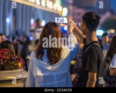 HARBIN, CHINA - JUNE 13, 2021 - People visit the central street of ...