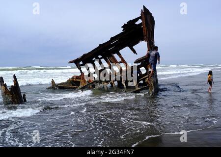Climbing on the wreck of the Peter Iredale in Fort Stevens State Park ...
