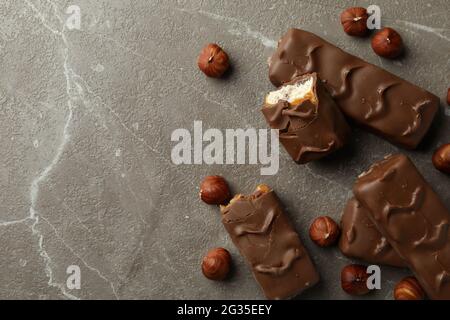 Candy bars and nuts on gray textured table Stock Photo - Alamy