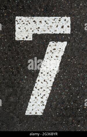 7, number seven, white stencil number on cobblestone surface Stock ...