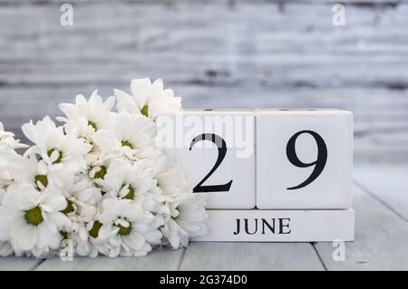 June 29th. Day 29 of month, Calendar date. Red Hole in the white paper ...