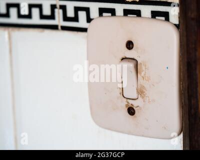 Dirty light switch on tiled wall close up, urban exploration Stock ...