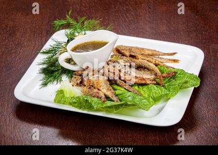 Fried barabulka fish snack with sauce Stock Photo - Alamy