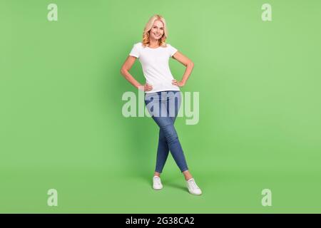Photo of adorable cute lady wear green bright clothes raise hand red ...