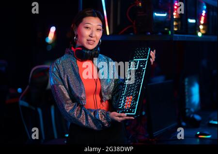 An experienced asian gamer shows a gaming keyboard and talks about its ...