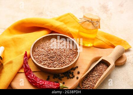 Bowl with flax seeds, oil and chili peppers on wooden background Stock ...