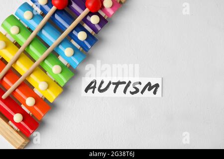 Word AUTISM and xylophone on light background Stock Photo - Alamy