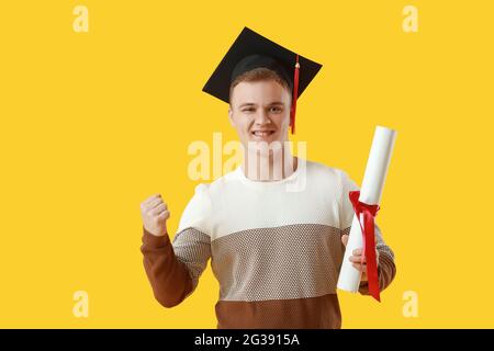 Happy graduating student on color background Stock Photo - Alamy