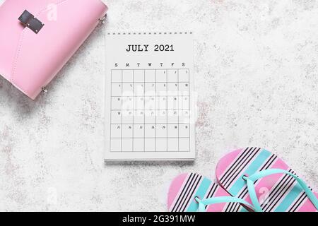Calendar, bag and flip-flops on light background Stock Photo - Alamy