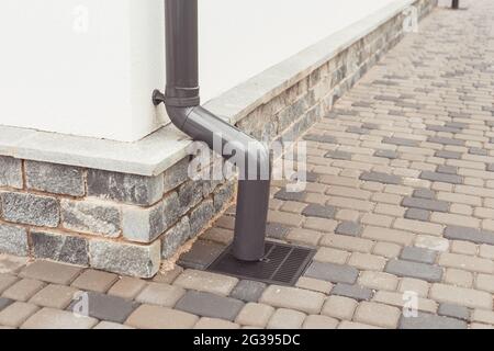stormwater pipe on facade with rainwater drainage into drainage system ...