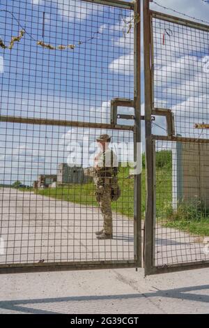 British Army soldier guarding the entrance to a secure base compound on ...