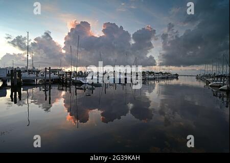 Bright summer cloudscape reflected in tranquil water of Dinner Key ...