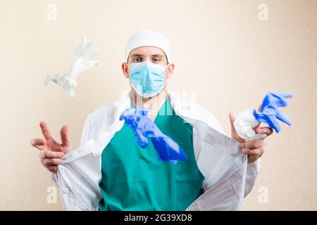 The doctor plays and throws up his gloves. On a light background Stock ...