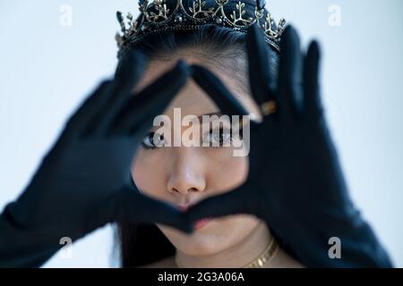 Dark hair asian girl wearing crown Stock Photo - Alamy