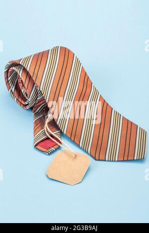 Silk tie with blank label on blue as a fathers day gift Stock Photo - Alamy