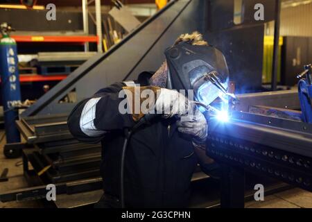A welder working at Universal Wolf ( a local manufacturing business ...