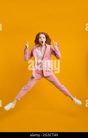 Redhead businesswoman wearing elegant red dress standing over isolated ...