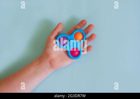 Children's Hand Holding Silicone Toy Spinner Simple Dimple Stock Photo ...