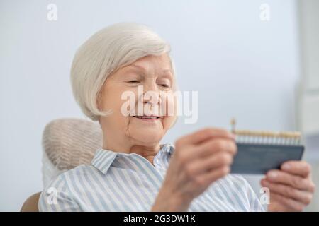 Senior woman at the dentists office with denture in hands Stock Photo ...